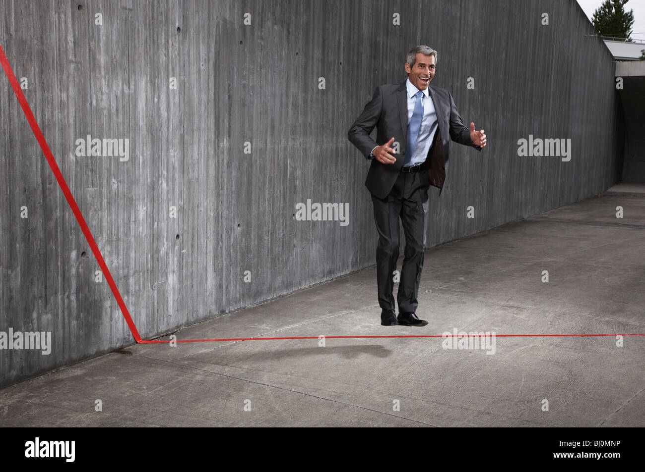 businessman standing behind red line Stock Photo - Alamy