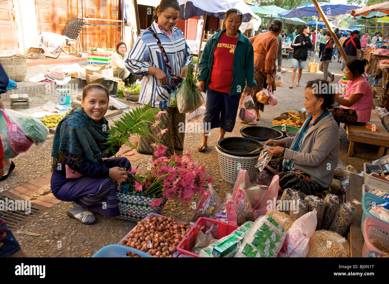 Buying flowers in Luang Prabang's early morning market Stock Photo - Alamy