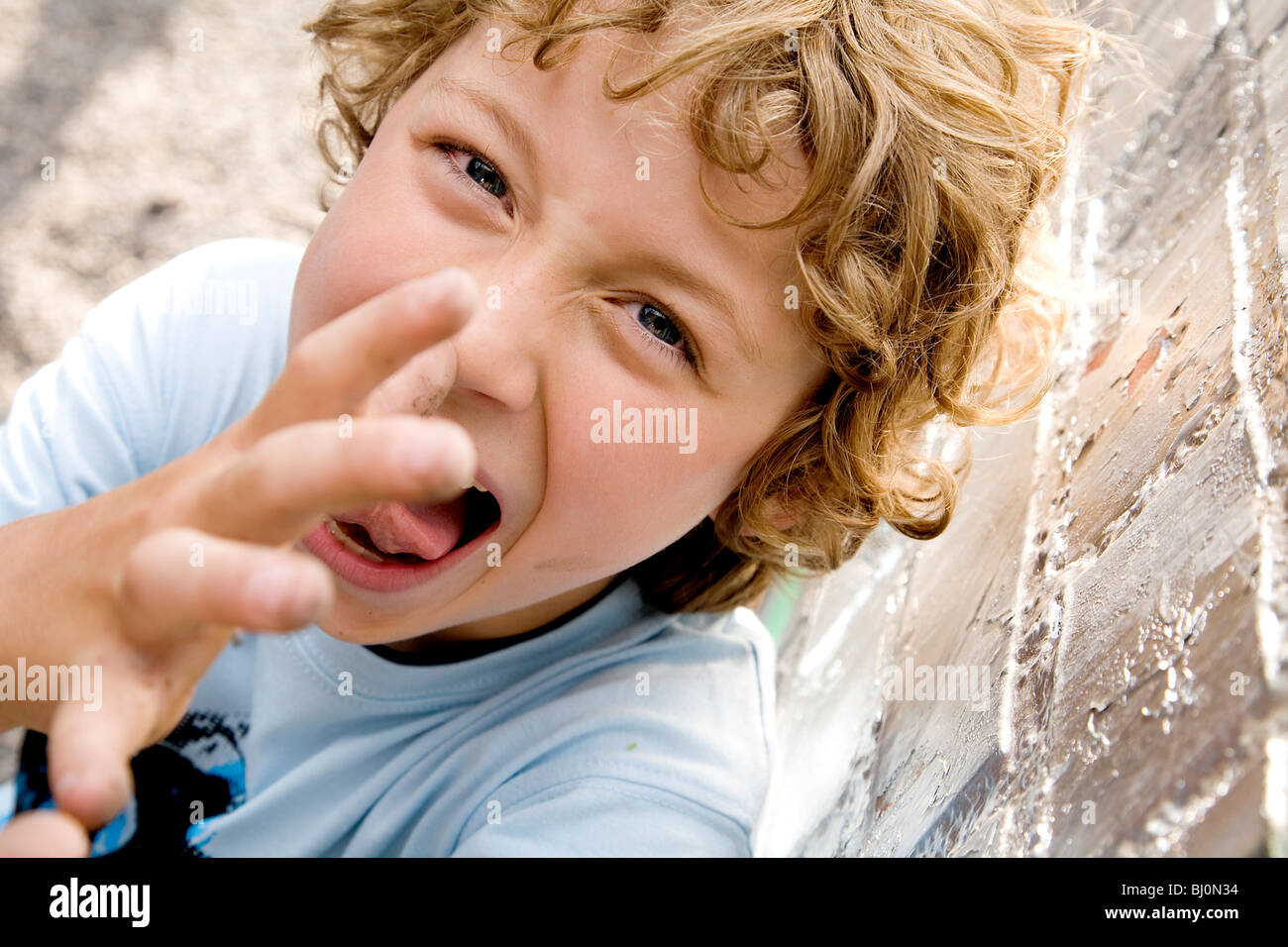 portrait of young boy thumbing his nose at camera Stock Photo - Alamy