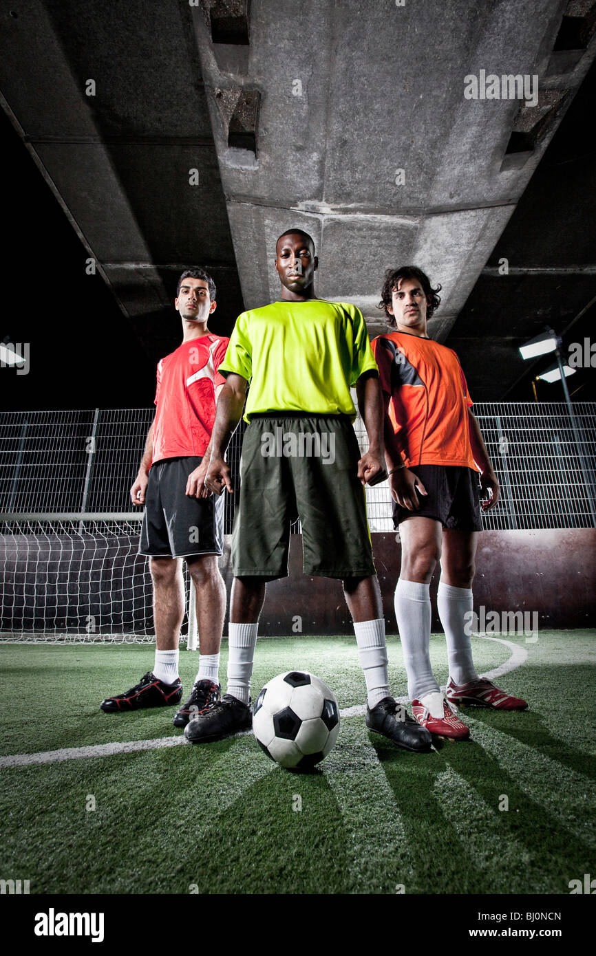 full body portrait of three street football players Stock Photo - Alamy