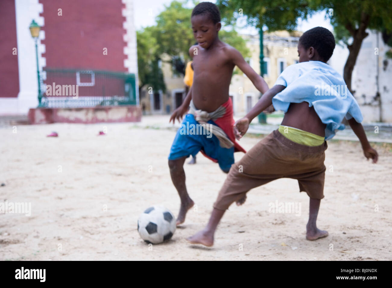 two boys playing football on the island of mozambique Stock Photo - Alamy