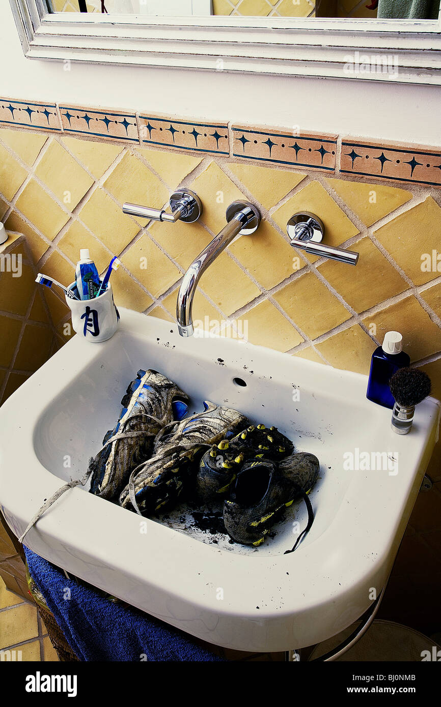 football boots in sink waiting to be cleaned Stock Photo - Alamy