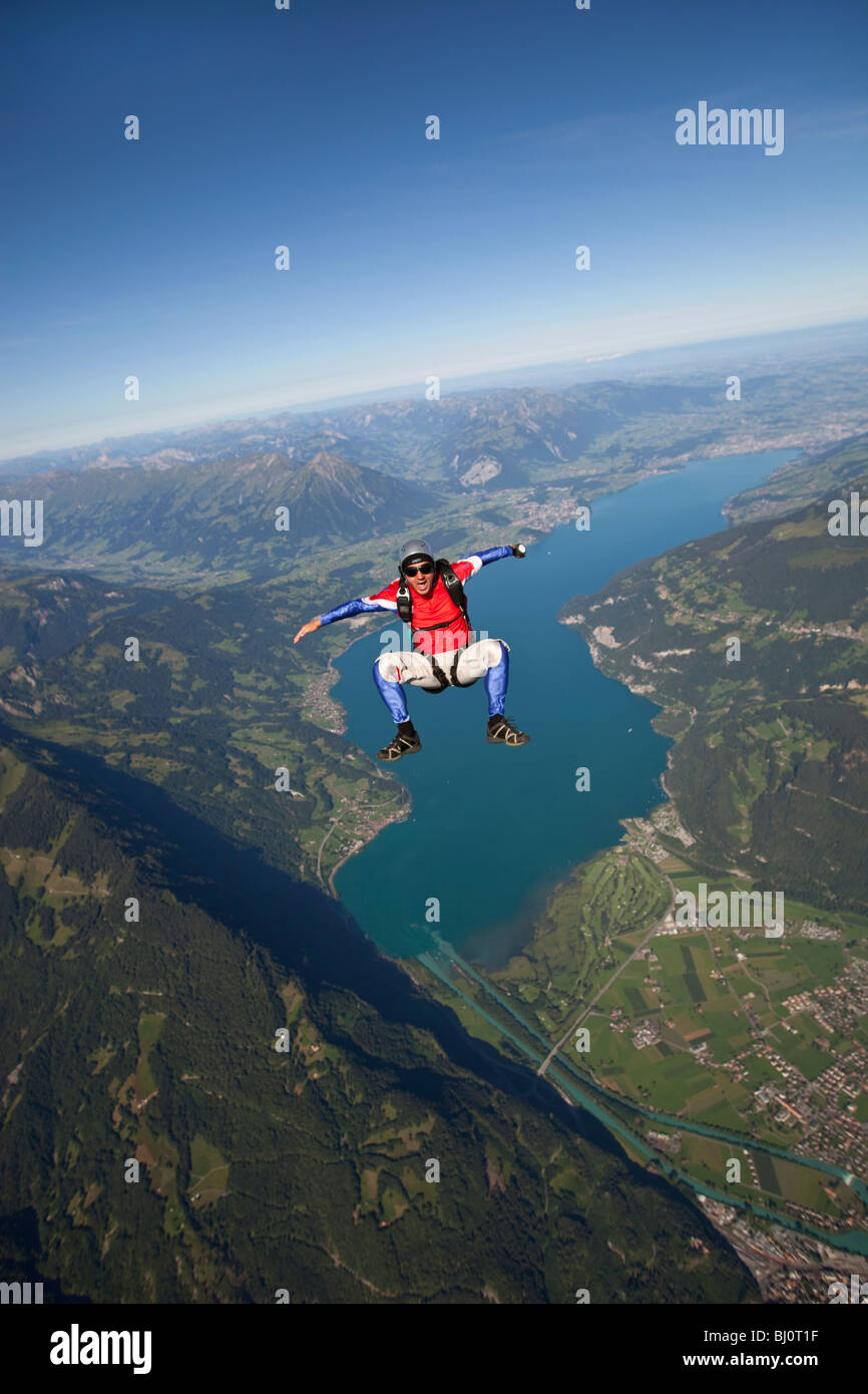 Skydiver is flying head up within the sit fly position over a ...