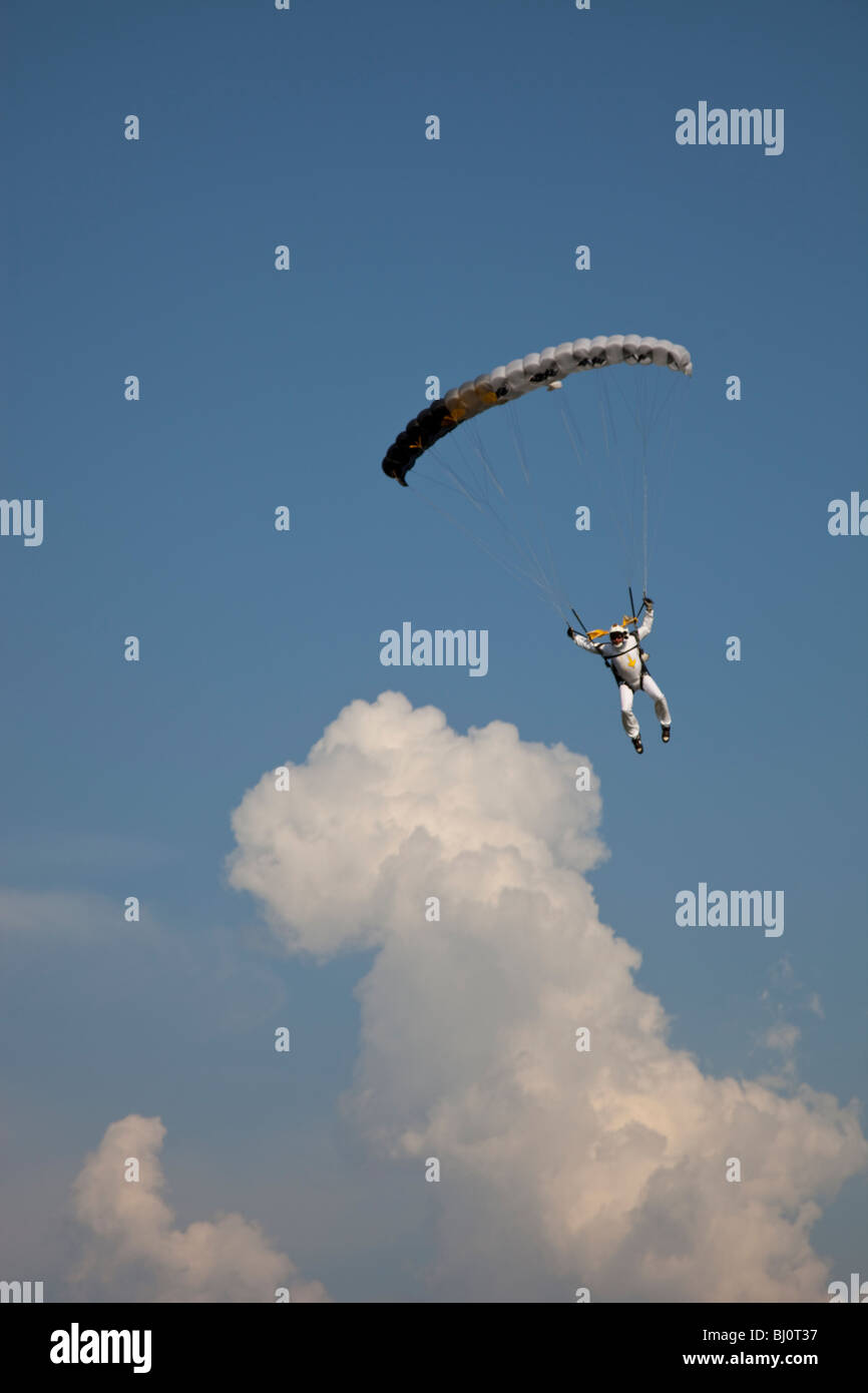 Skydiver under canopy is flying around the clouds. The perfect way to ...