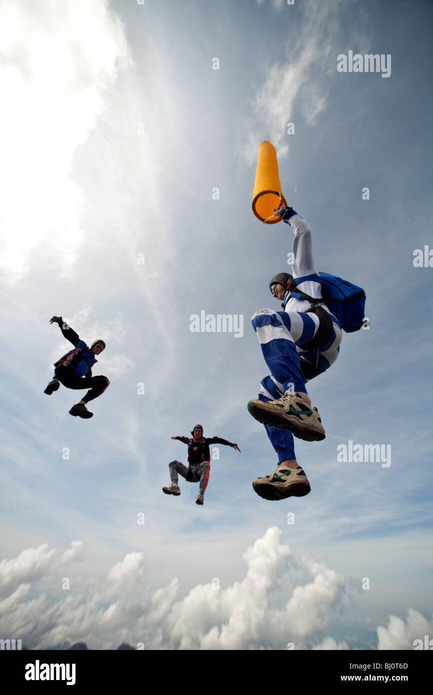 Skydiver are flying head up within a team in the sit fly position over ...