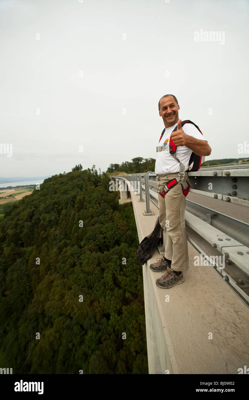 BASE jumper getting ready to jump the high way bridge. Fun but extreme ...
