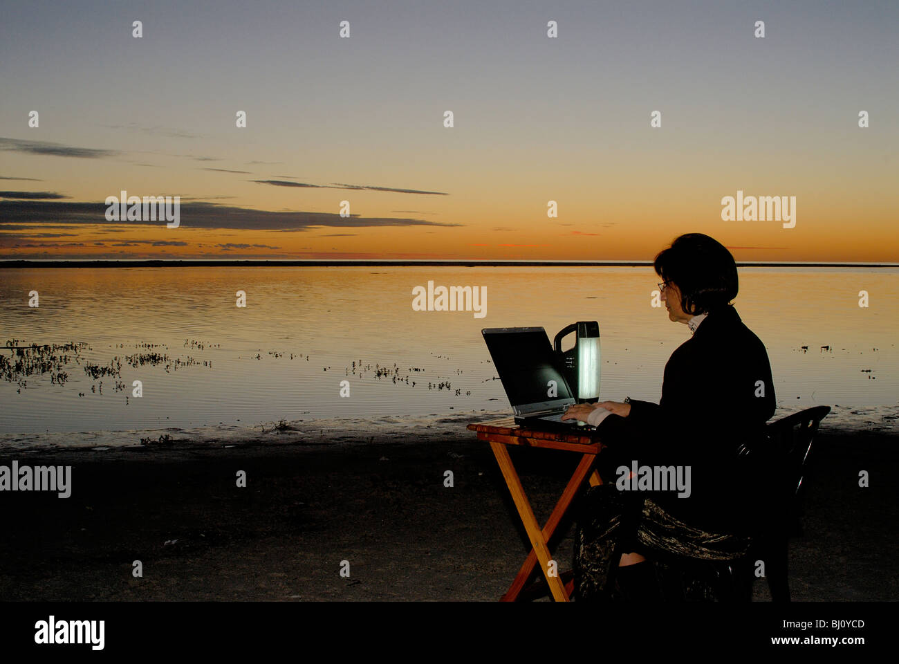 Freelance writer working in inspiring beach and sunset location Stock ...