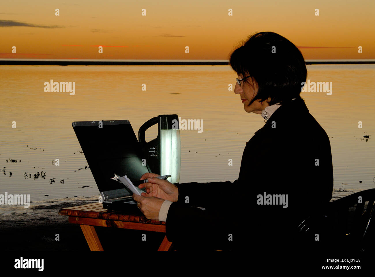 Freelance writer working in inspiring beach and sunset location Stock ...