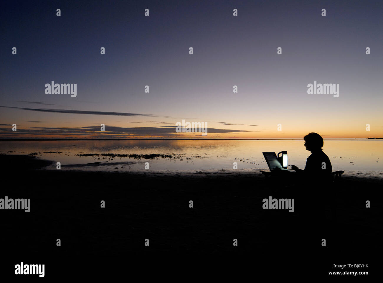 Freelance writer working in inspiring beach and sunset location Stock ...