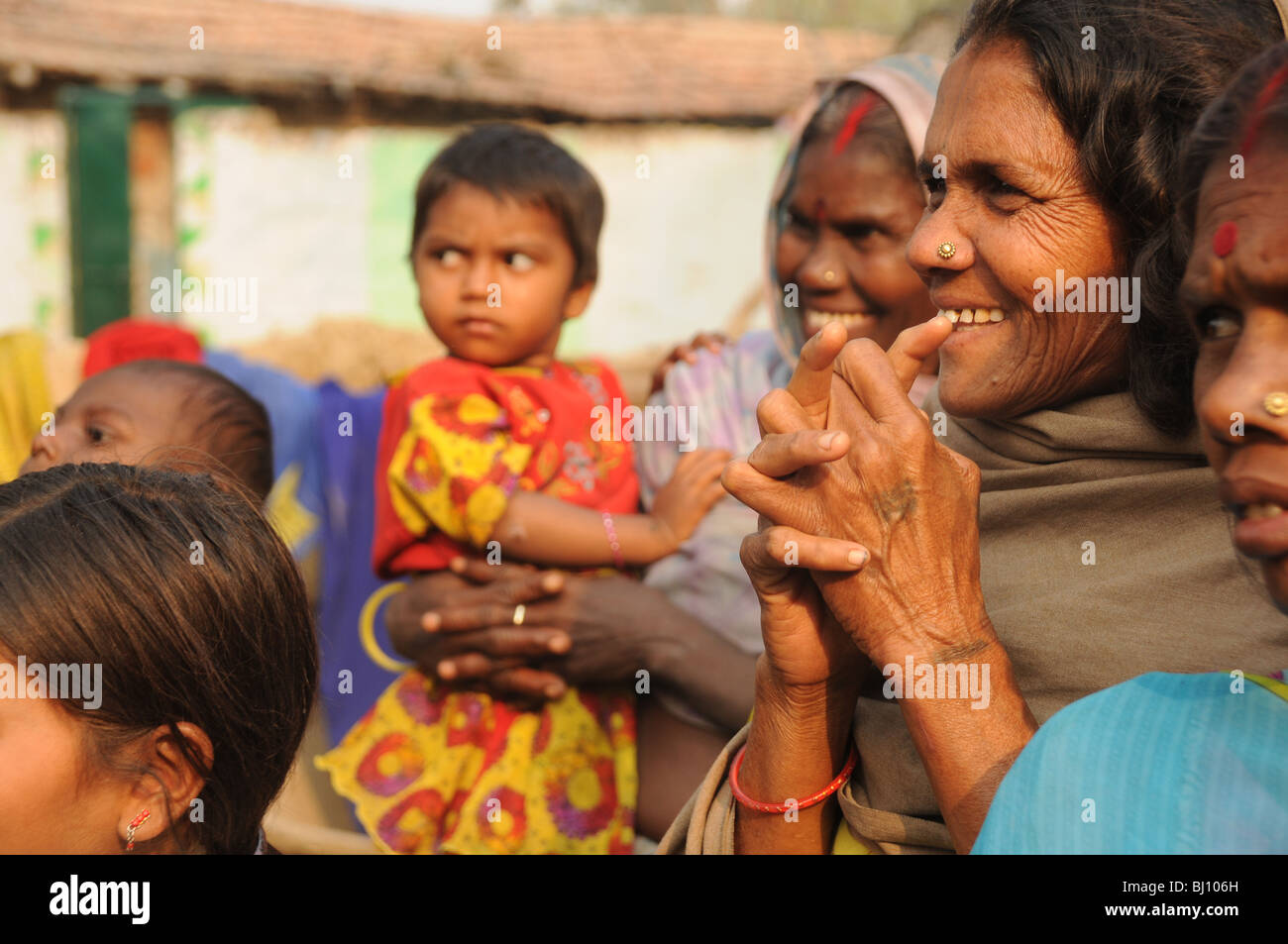 Smiling crowd and lady looking across camera frame Stock Photo - Alamy