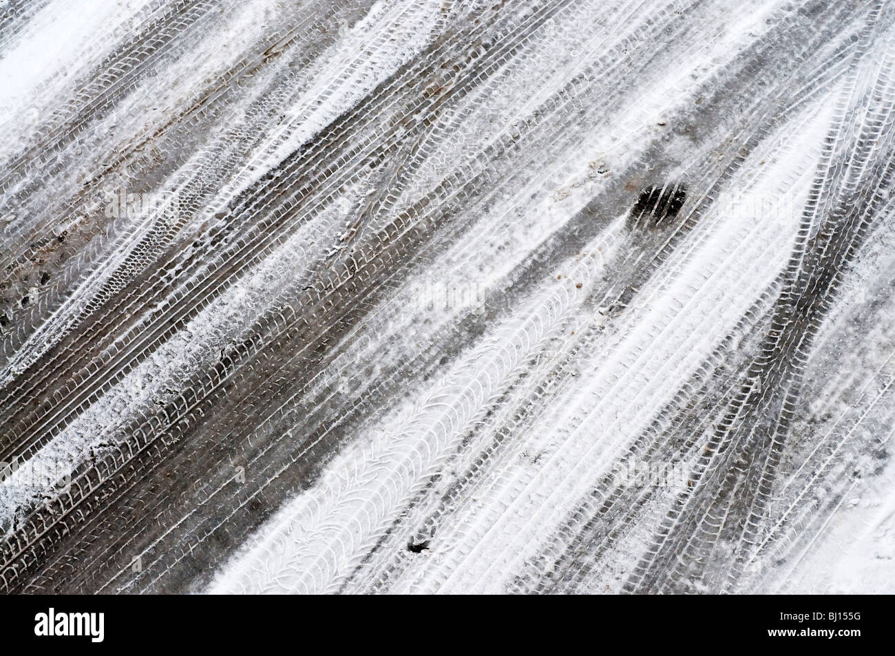 Melting car tracks on snow covered road - France Stock Photo - Alamy