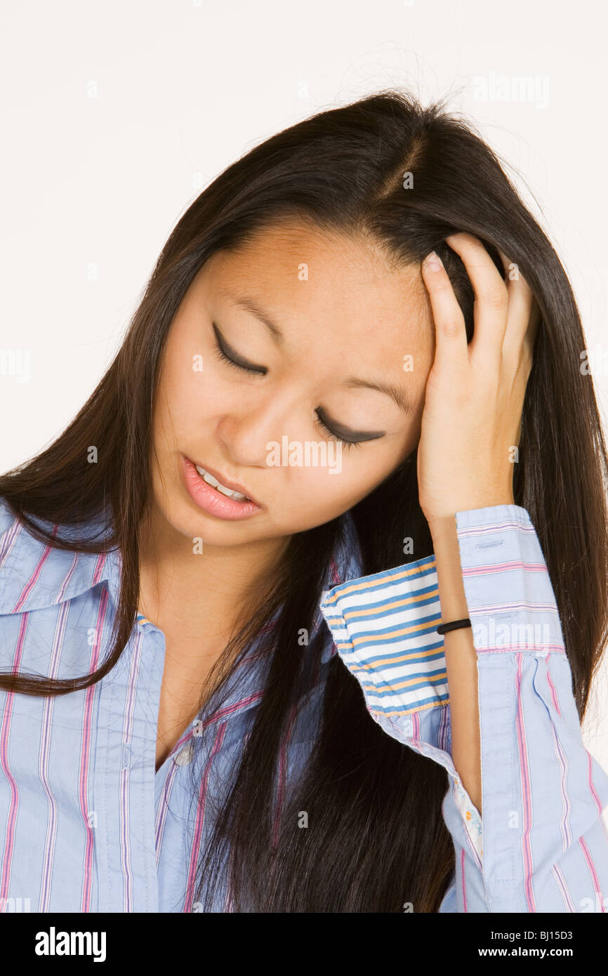 Asian woman looking worried Stock Photo - Alamy