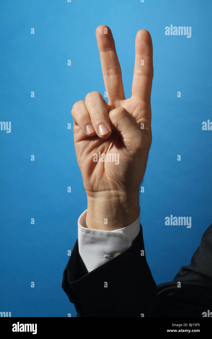 Hand showing victory sign Stock Photo - Alamy