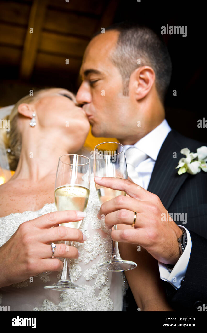 Bride and groom, wedding toast in front of a window Stock Photo - Alamy