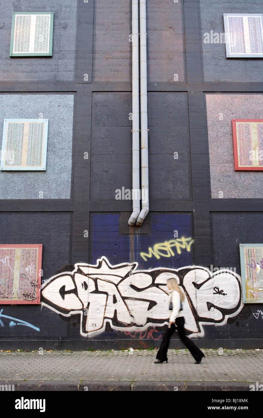 Woman passing by graffiti inscriptions, Saarbruecken, Germany Stock ...
