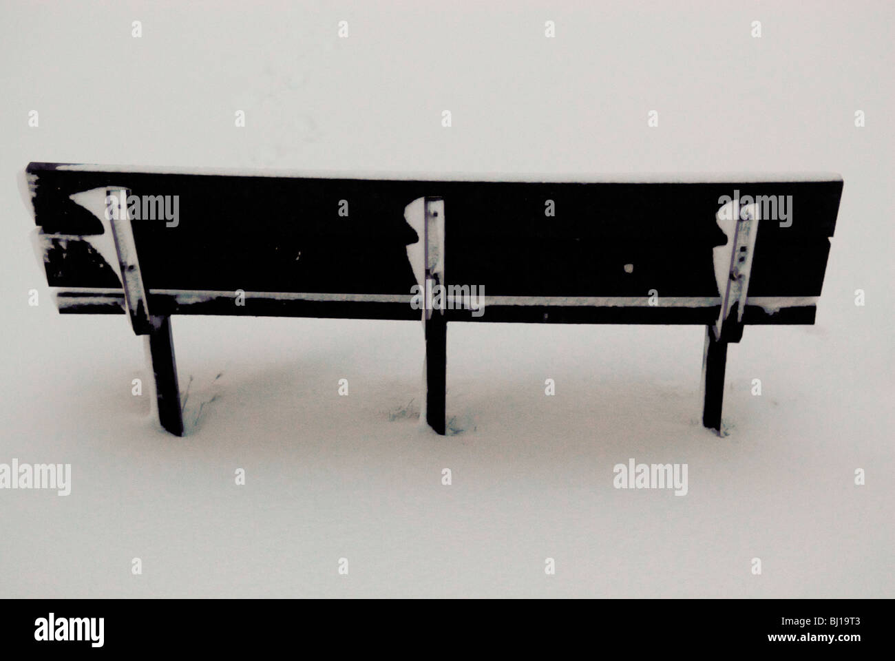 View of bench in park from behind after heavy snowfalls Stock Photo - Alamy