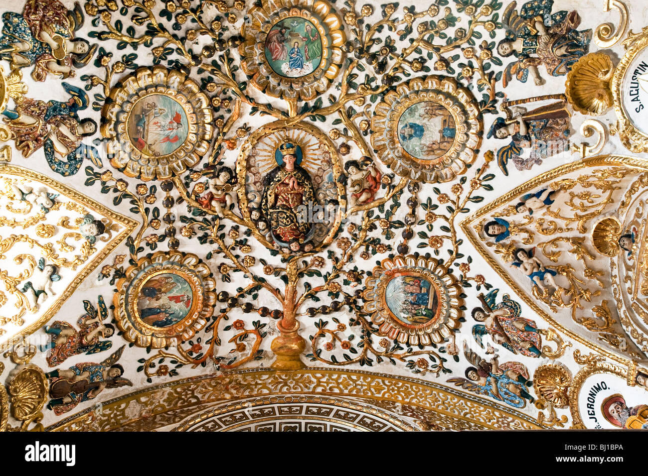 section of richly gilded ceiling of Rosary Chapel with central Virgin ...
