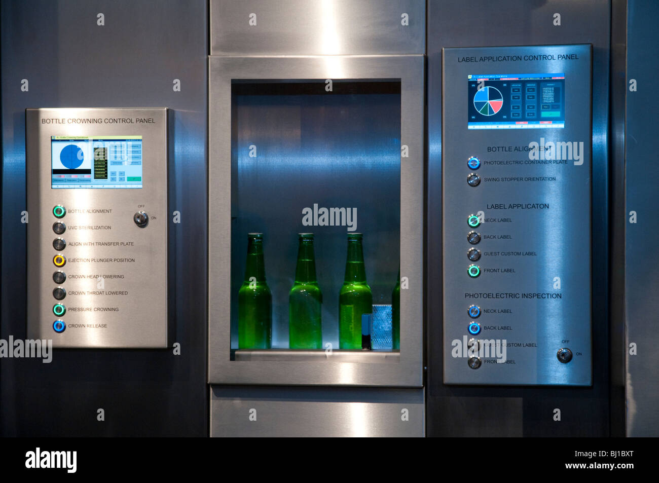 Glass bottles being processed and labelled during the beer production ...