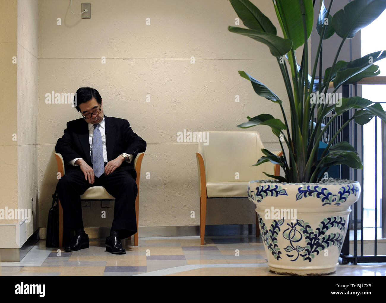 A salaried worker takes a snooze inside a department store in Tokyo ...