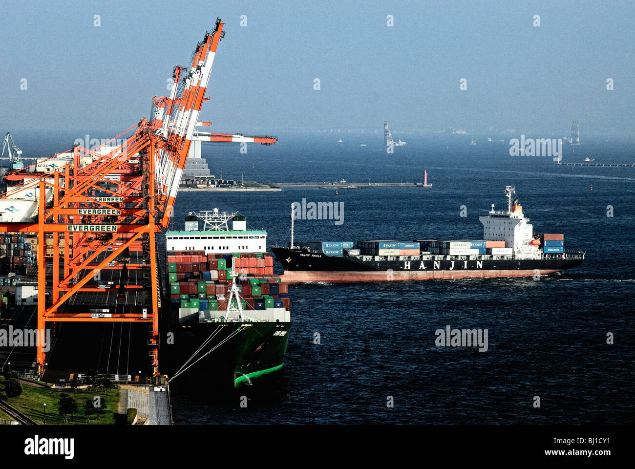 Cargo ships by loading cranes in Tokyo Bay, Tokyo, Japan Stock Photo ...