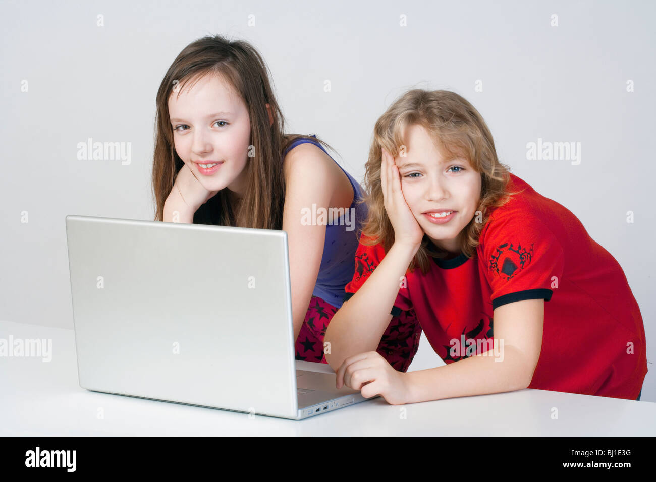 young boy and girl having fun with laptop computer Stock Photo - Alamy