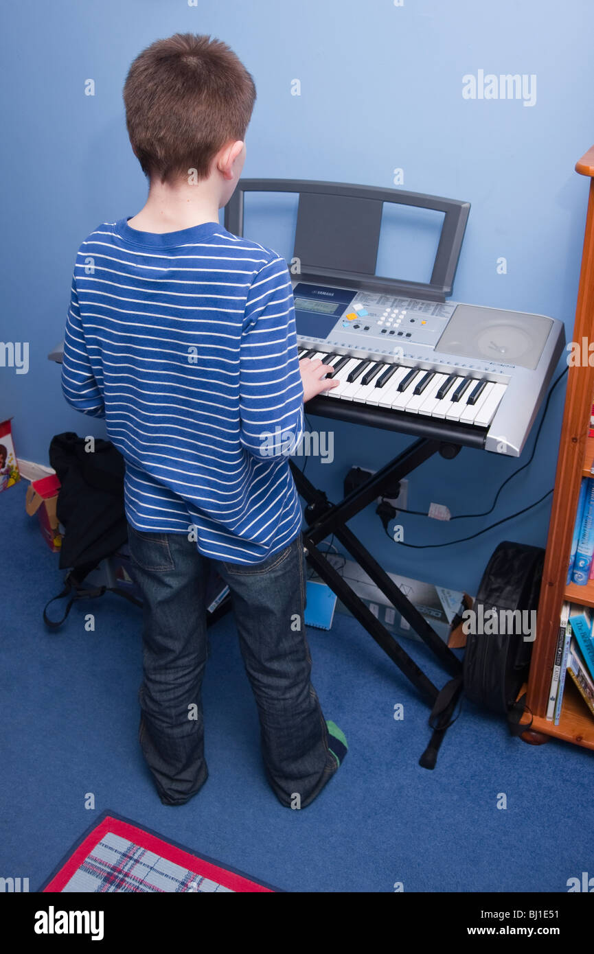 A MODEL RELEASED picture of a 10 year old boy playing his keyboard in ...