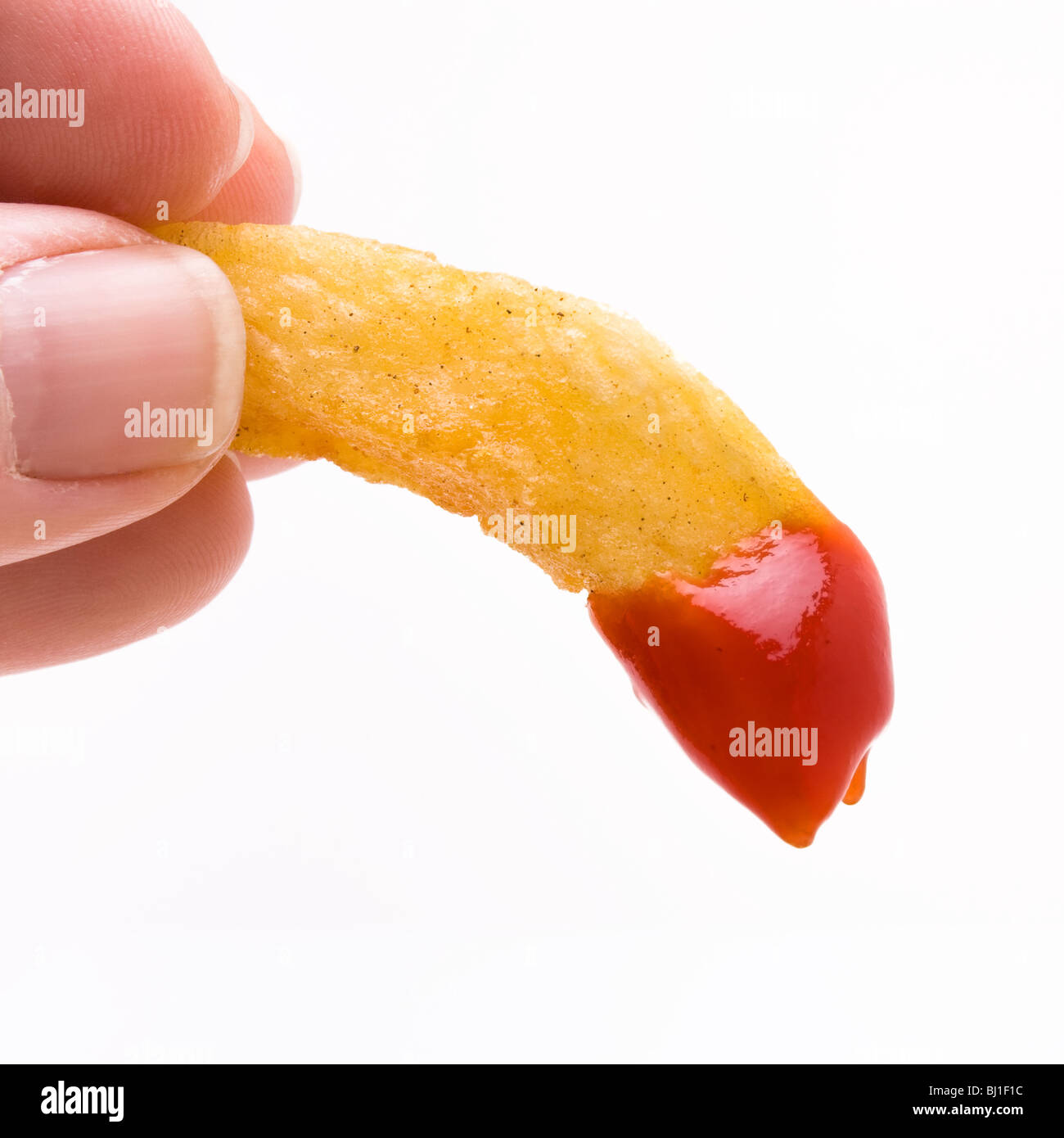 English Chip shop chip dripping tomato ketchup isolated against white ...