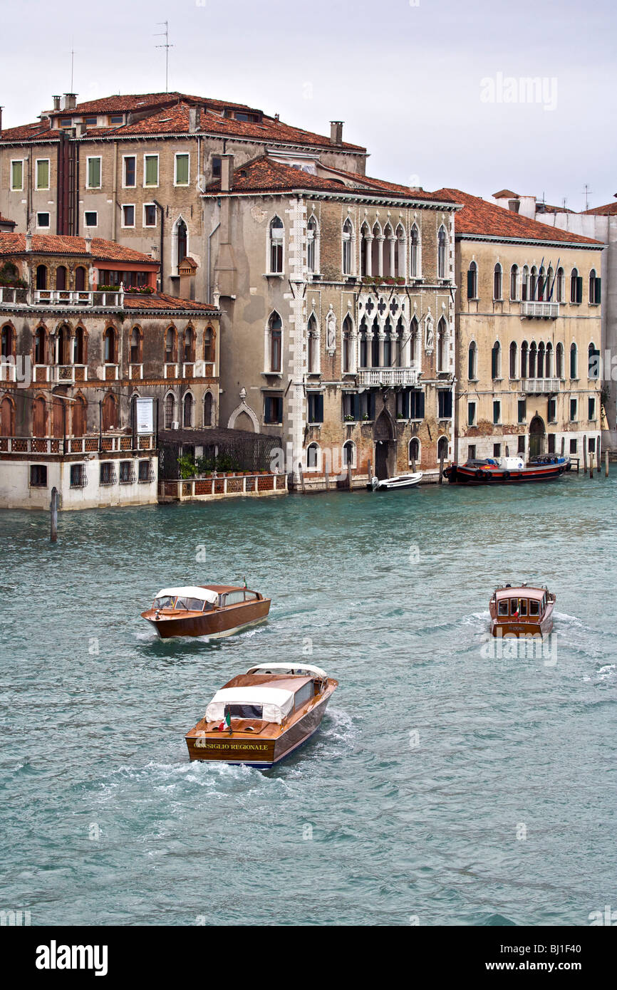 Three motorboats making their way along the Grand Canal in Venice ...