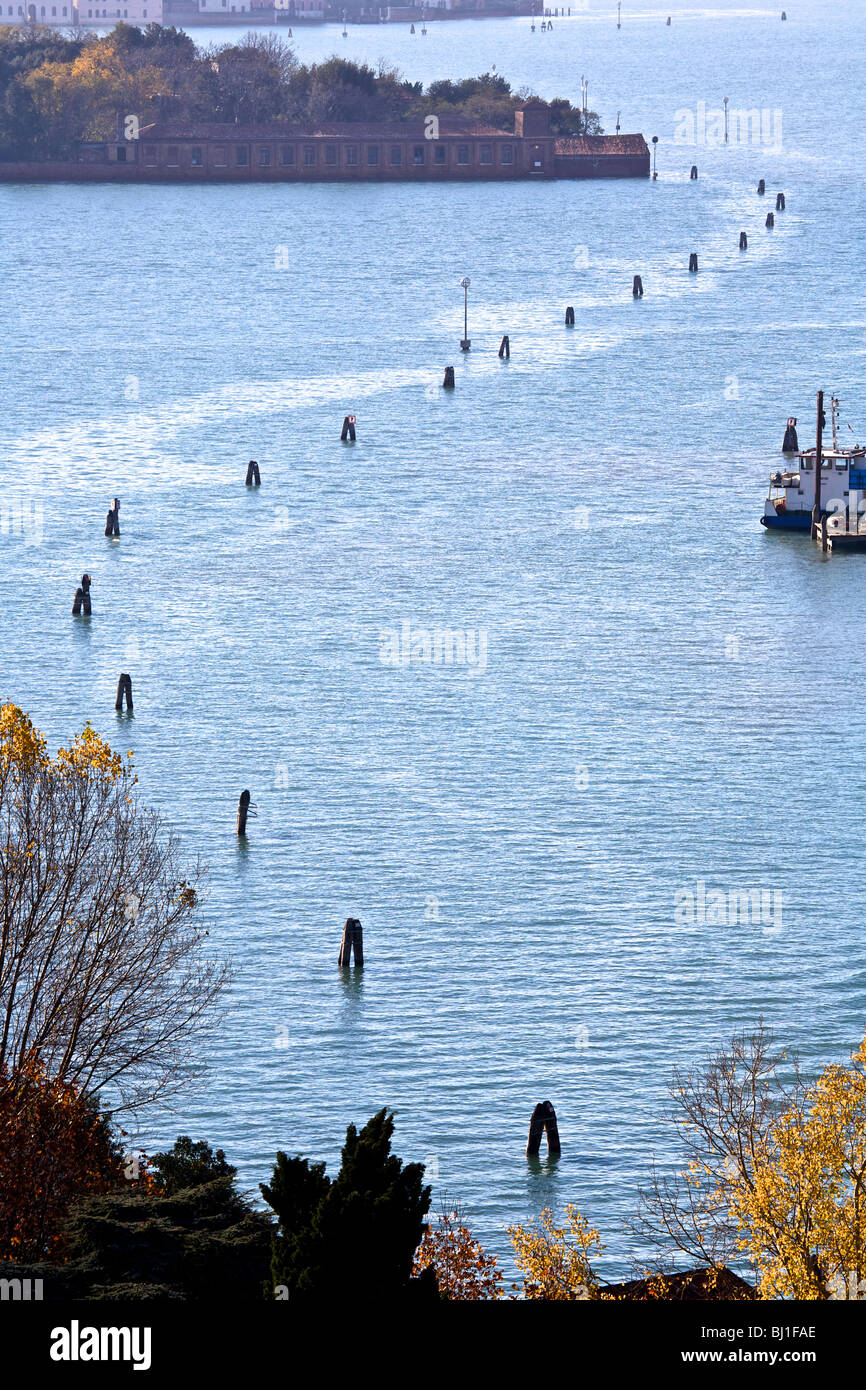 Shipping bollards curving across the lagoon/Grand Canal in Venice ...