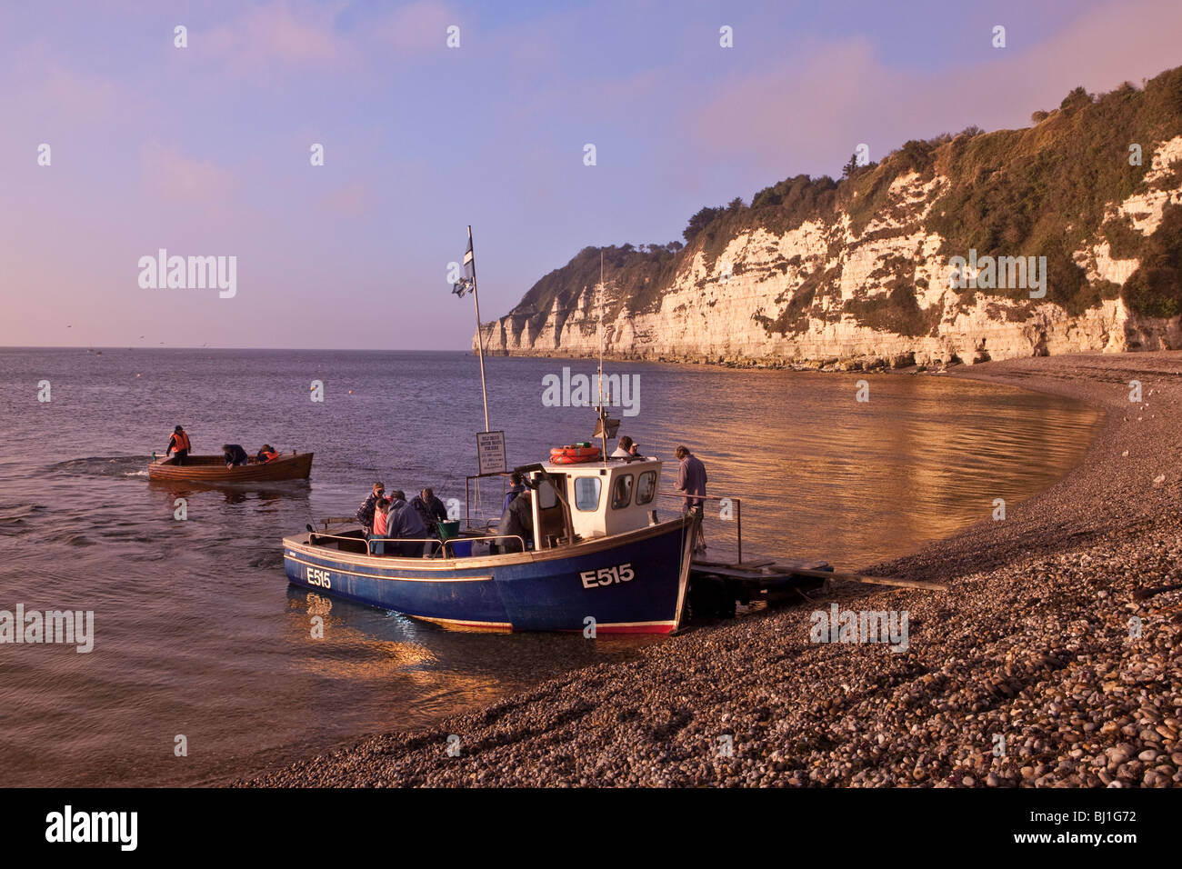 Fishing trip; boat boarding on the beach at Beer, Devon Stock Photo - Alamy