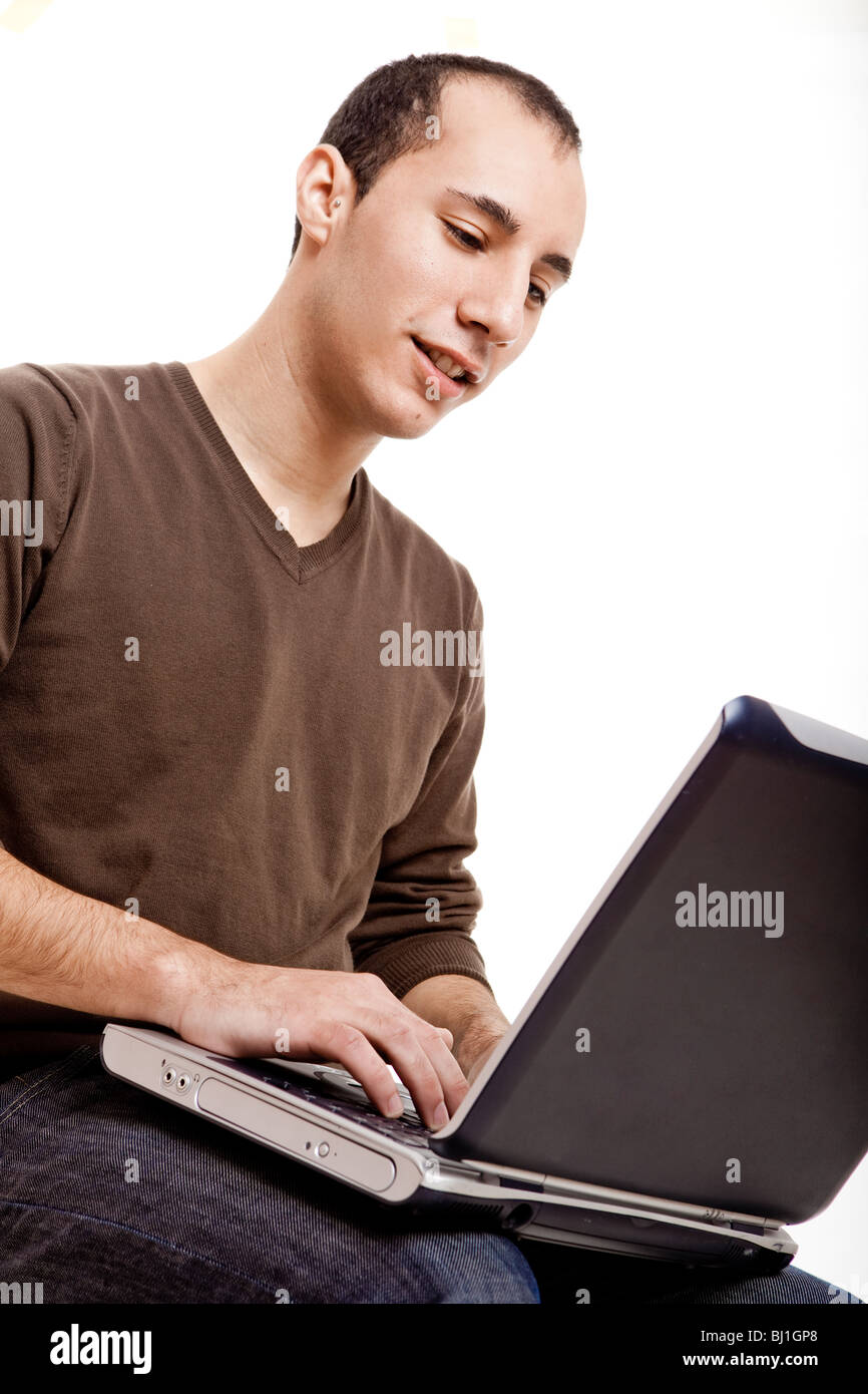 Young man working on a laptop, isolated on white Stock Photo - Alamy