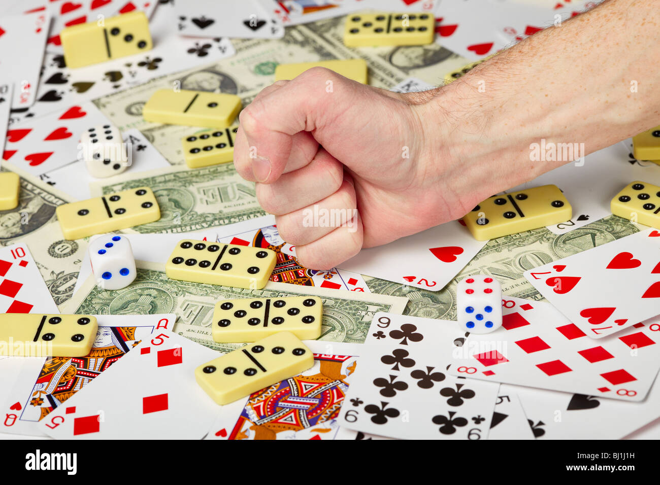 The hand clenched in a fist strikes the playing cards Stock Photo - Alamy