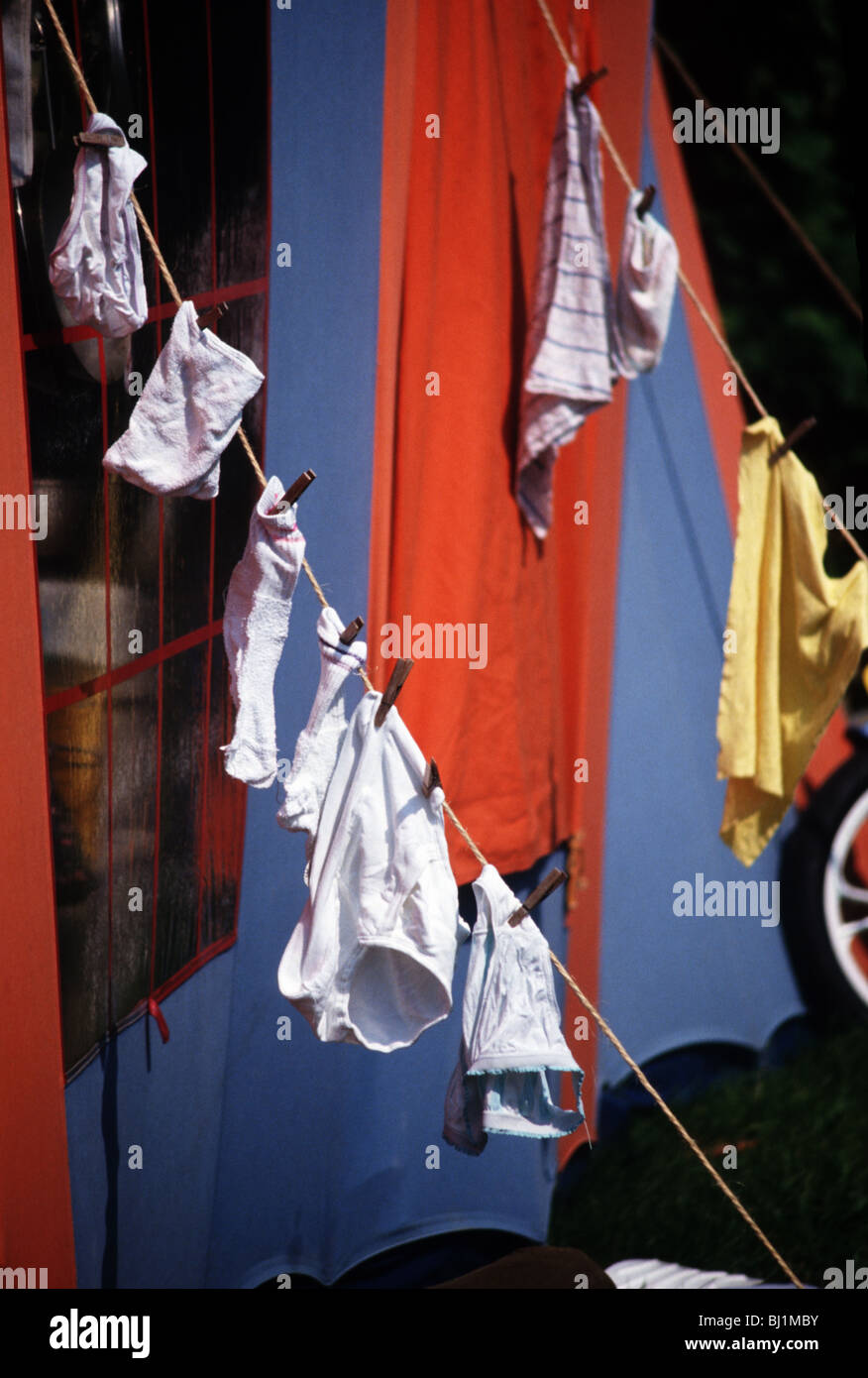 Clothes hand wash drying on tent line on camping site Stock Photo - Alamy
