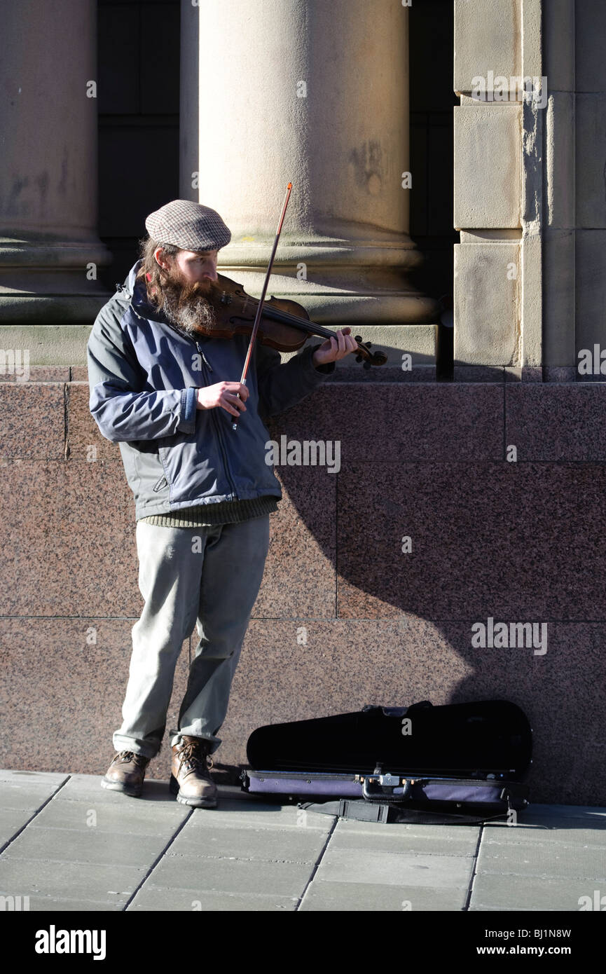 A Man busking on the street, playing the violin, Aberystwyth Wales UK ...