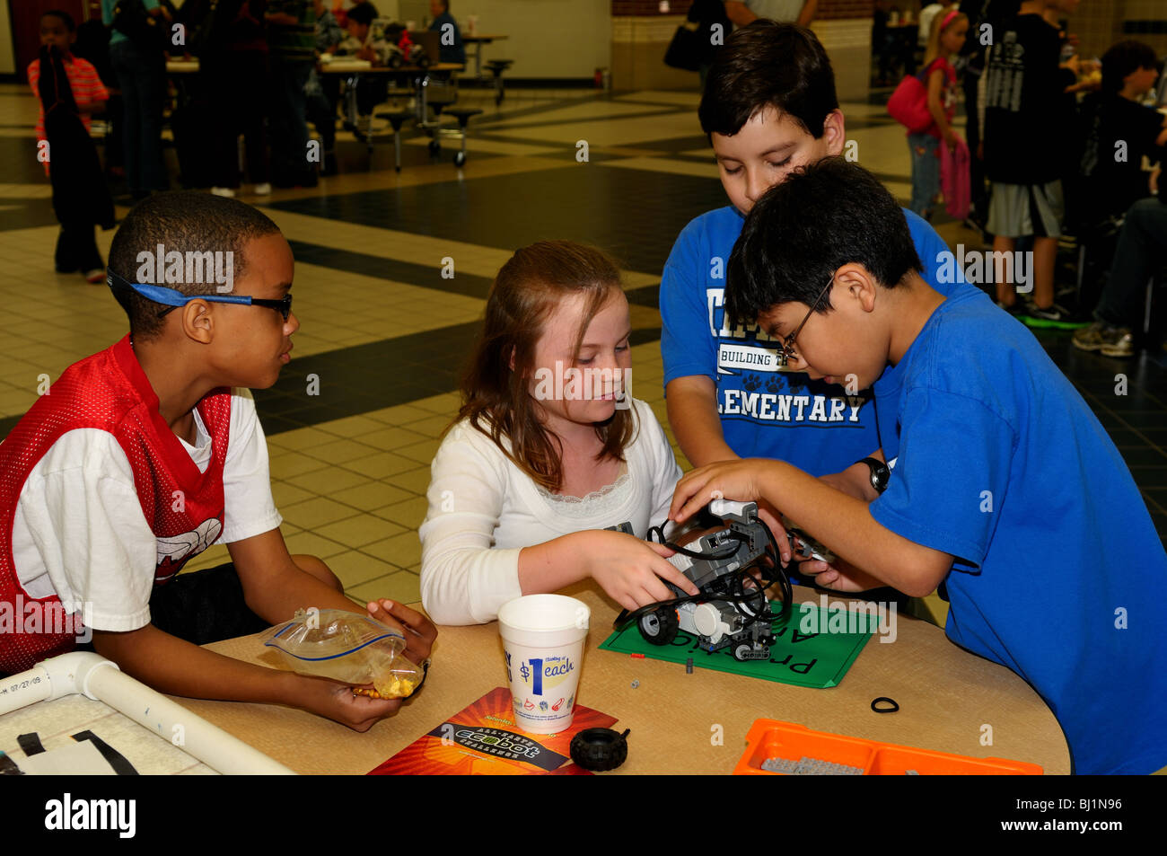 A group of elementary school students working on an engineering project ...