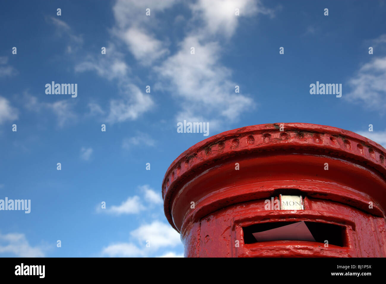 Red British Royal Mail letterbox with half posted letter pictured ...