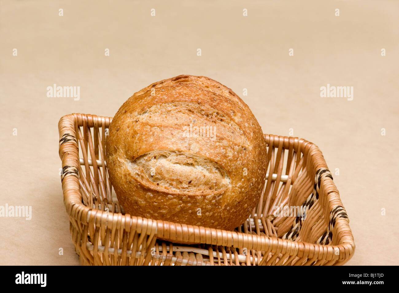 Bread in a basket on neutral background Stock Photo - Alamy