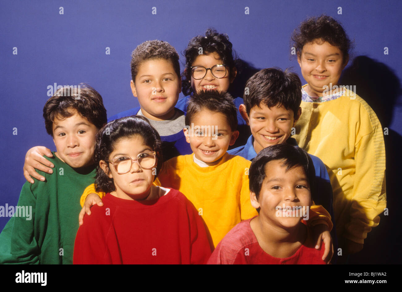 Group Hispanic kid boy girl laugh fun hug smile friend touch Stock ...