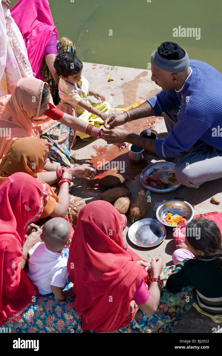 Hindu pilgrims making a ritual offering (puja). Brahma Ghat. Pushkar ...