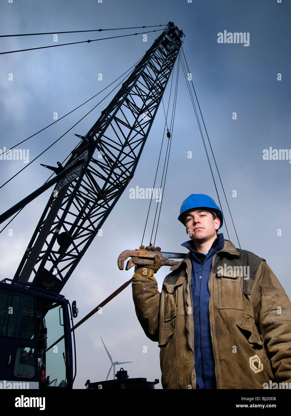Crane driver wearing hard hat posing in front of his crane. Amsterdam ...