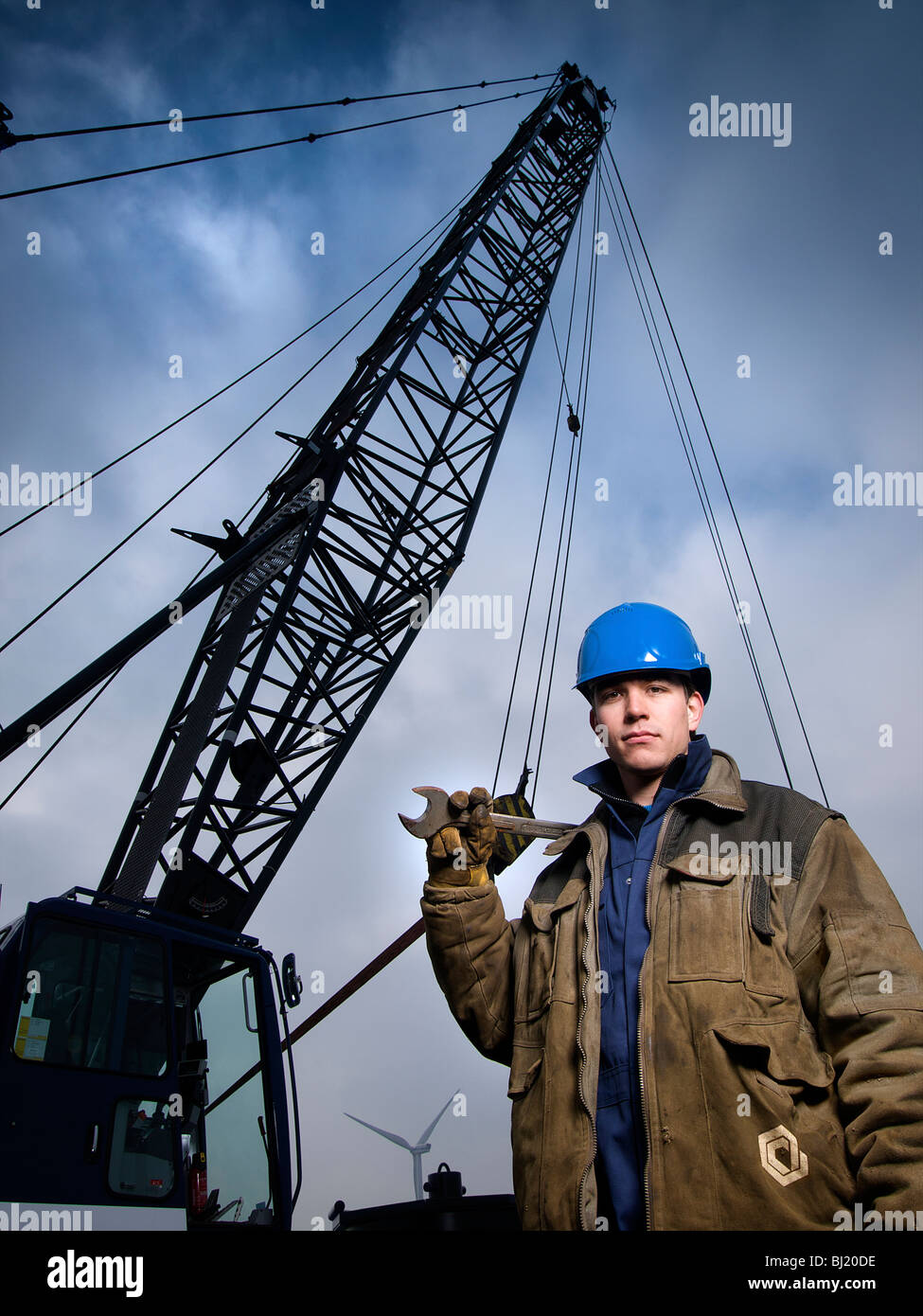 Crane driver wearing hard hat posing in front of his crane. Amsterdam ...