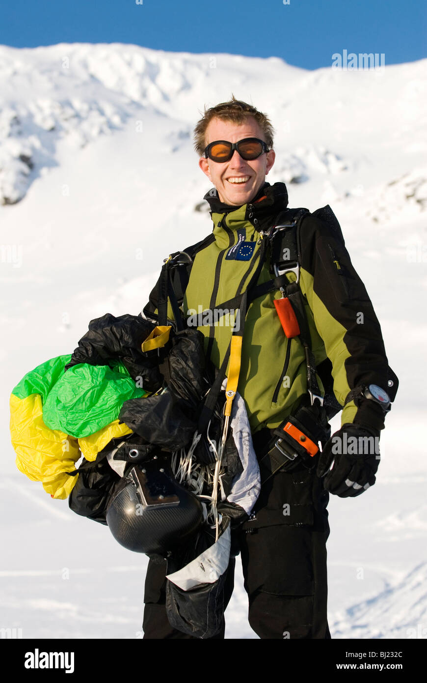 A man with a parachute in his hand in front of a mountain, Sweden Stock ...