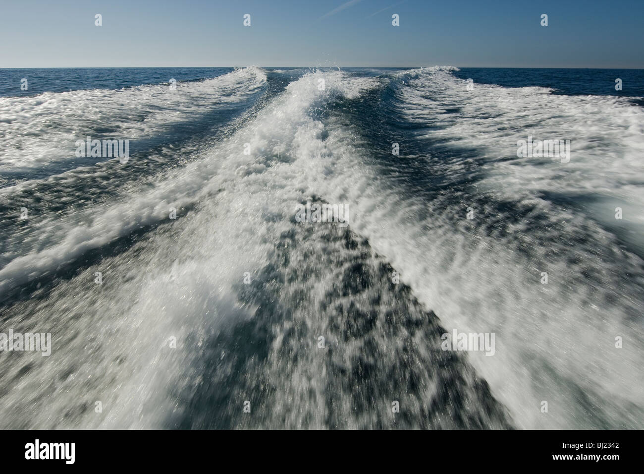 Waves behind a boat Stock Photo - Alamy