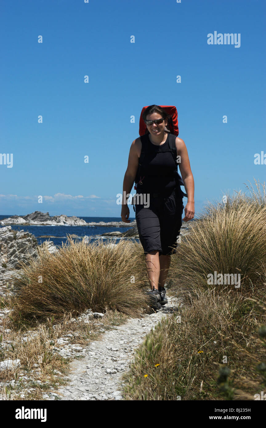 A woman walking on a narrow path Stock Photo - Alamy