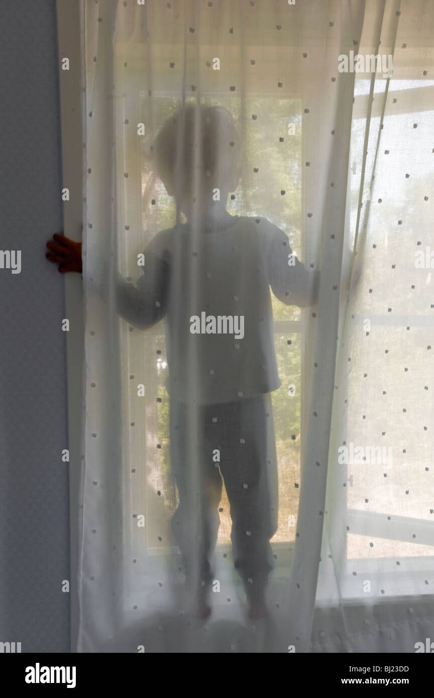 Silhouette boy standing behind curtain hi-res stock photography and ...