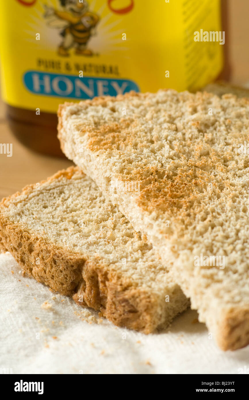 Wholemeal toast with honey jar Stock Photo - Alamy