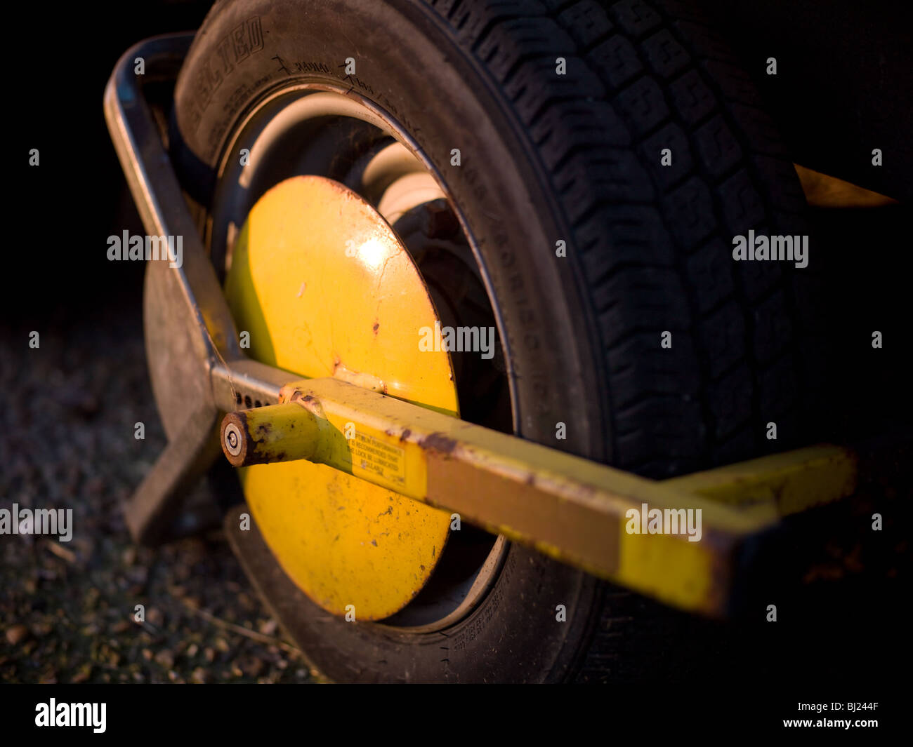 Yellow clamp immobilised impounded restricted security vehicle wheel hi ...