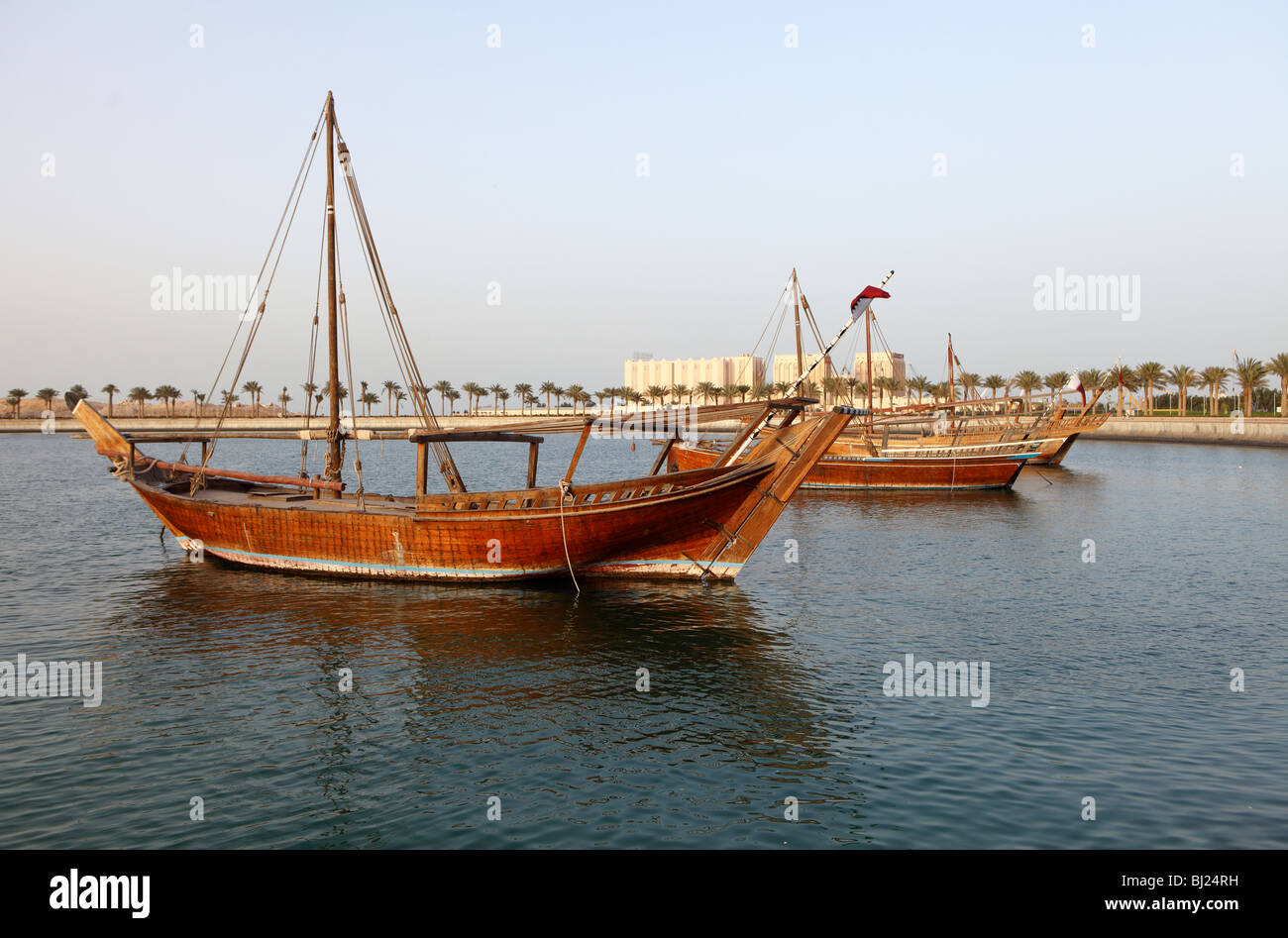 Various types of traditional Arab dhow moored off Doha Corniche Stock ...