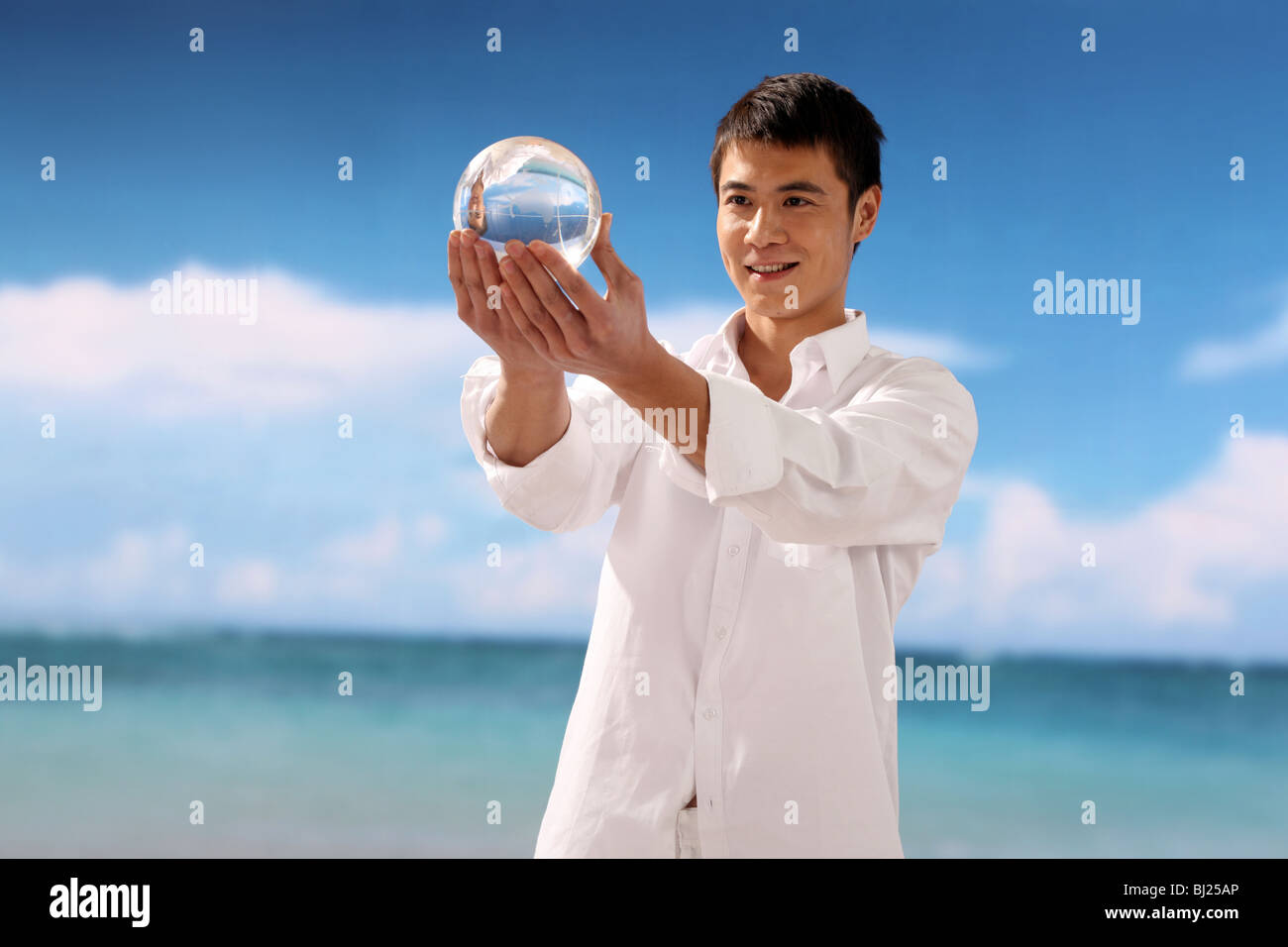 Man holding crystal ball Stock Photo - Alamy