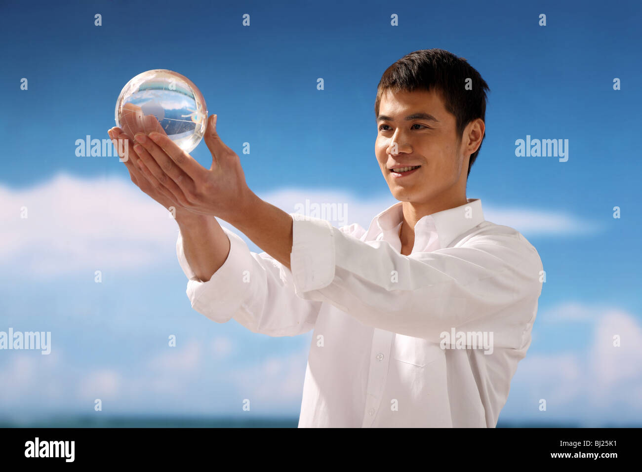Man holding crystal ball Stock Photo - Alamy